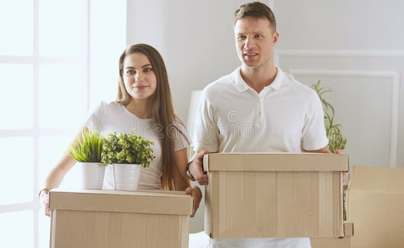 Happy Young Couple Moving in New Home Stock Photo - Image of carton ...
