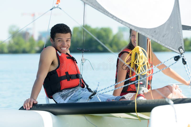 Happy young couple sailing stock image. Image of couple - 264391393