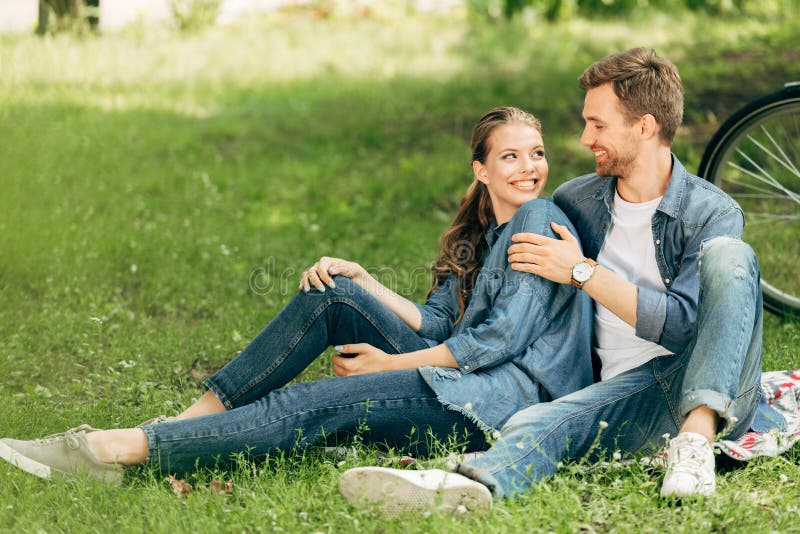 Happy Young Couple Sitting On Grass Stock Image Image Of Leisure