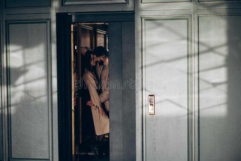 Happy Young Couple Standing Inside Elevator Cabin and Embracing Stock ...