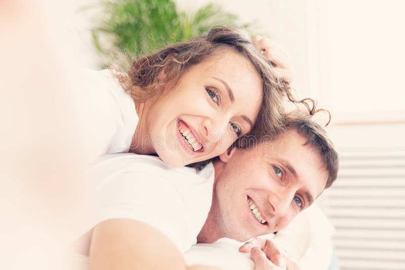 Happy Young Couple Taking Selfie On Bed In Bedroom Romantic Time
