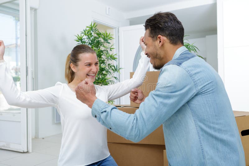 Happy Young Couple Unpacking Stock Image - Image of beautiful, moved ...