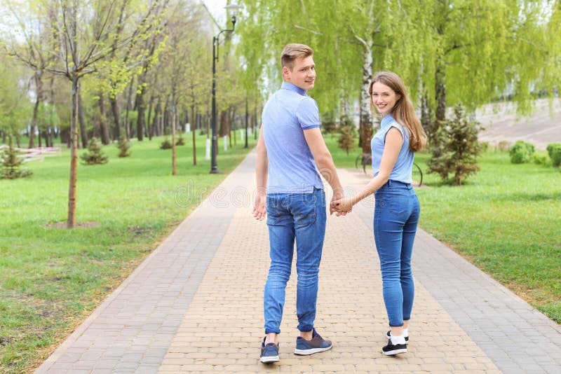 Happy Young Couple Walking in Park on Spring Day Stock Photo - Image of ...