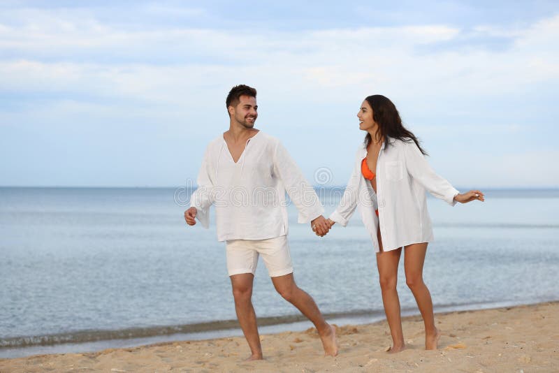 Happy Young Couple Walking Together on Beach Stock Image - Image of ... Happy Young Couple Walking Together on Beach Stock Image - Image of ...