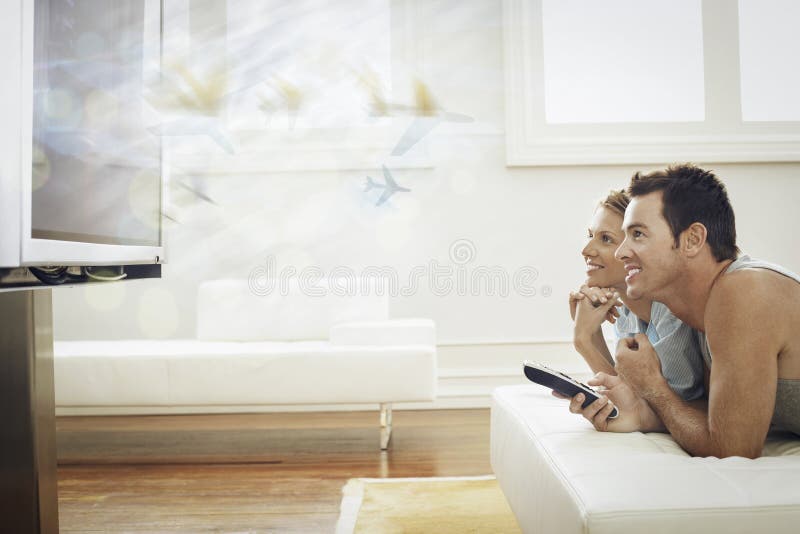 Happy Young Couple Watching TV at Home Stock Image - Image of composite ...
