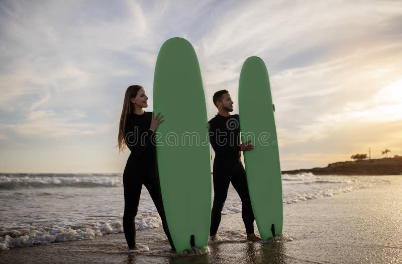 Beachside Romance. Portrait of Young Happy Couple Surfing Together on ...
