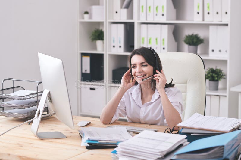 Happy Young Customer Support Representative with Headset Looking at ...