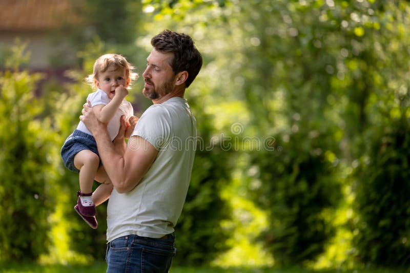 Happy Young Dad Playing with His Son and Looking Contented Stock Image ...