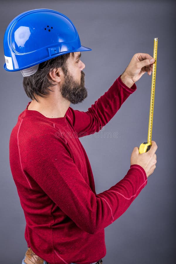 Happy Young Engineer with Hardhat Holding a Measuring Tape Stock Photo ...