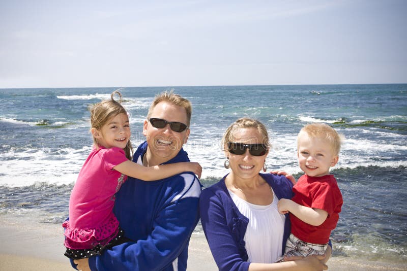 Family Fun on the Beach in the Sun Stock Photo - Image of hugging ...