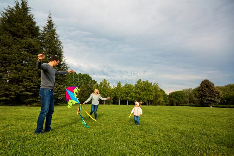 Happy Young Family with Flying a Kite. Stock Image - Image of outdoors ...