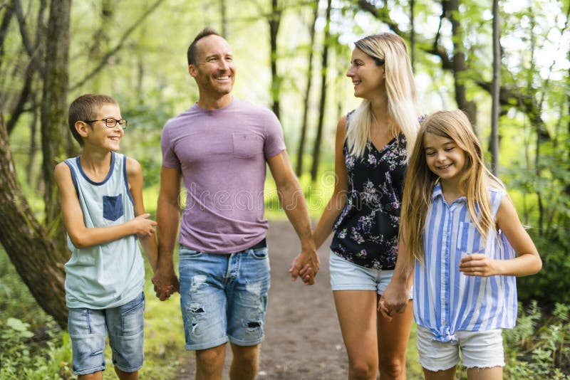 Happy Young Family in Forest Having Fun Together Stock Photo - Image of ...