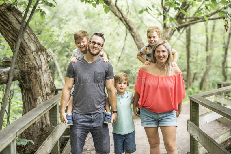 Happy Young Family in Forest Having Fun Together Stock Photo - Image of ...