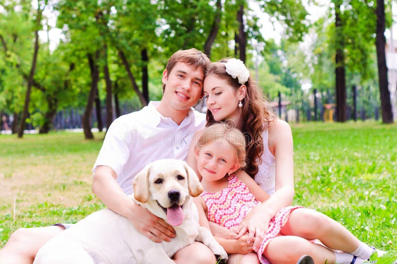 Happy Young Family with Labrador Stock Photo - Image of outdoors ...