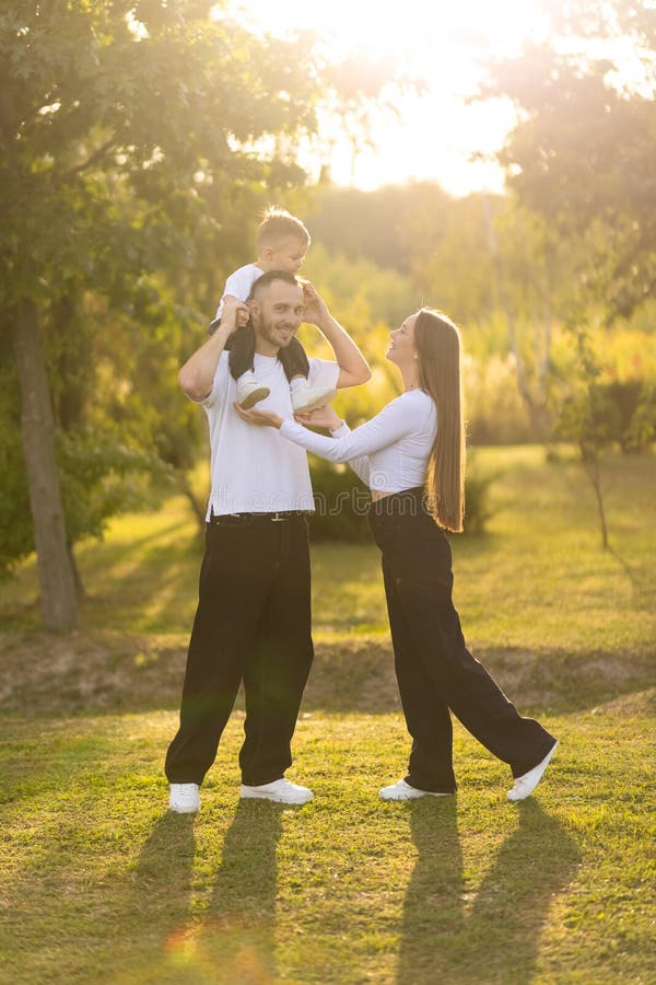 Happy Young Family with Son in Park Stock Photo - Image of family ...