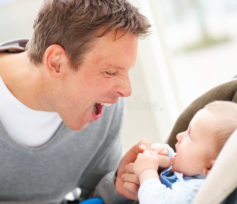 Happy Young Father Making a Funny Face at His Baby Stock Photo - Image ...