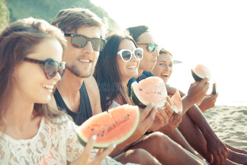 Friends Eating Watermelon on Beach Stock Photo - Image of watermelon ...