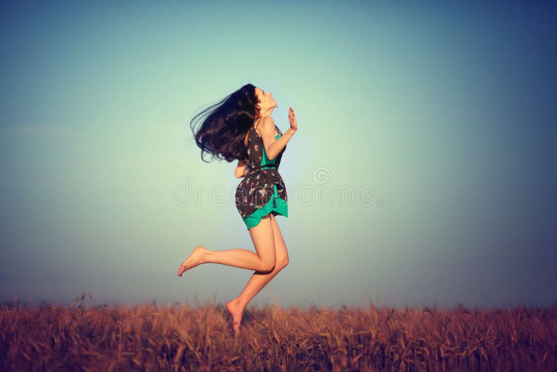 Happy young girl in field stock image. Image of jumping - 64182429