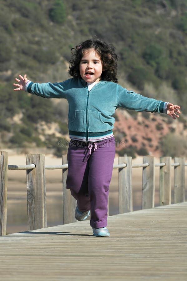 Happy young girl running stock photo. Image of clothes - 6941430