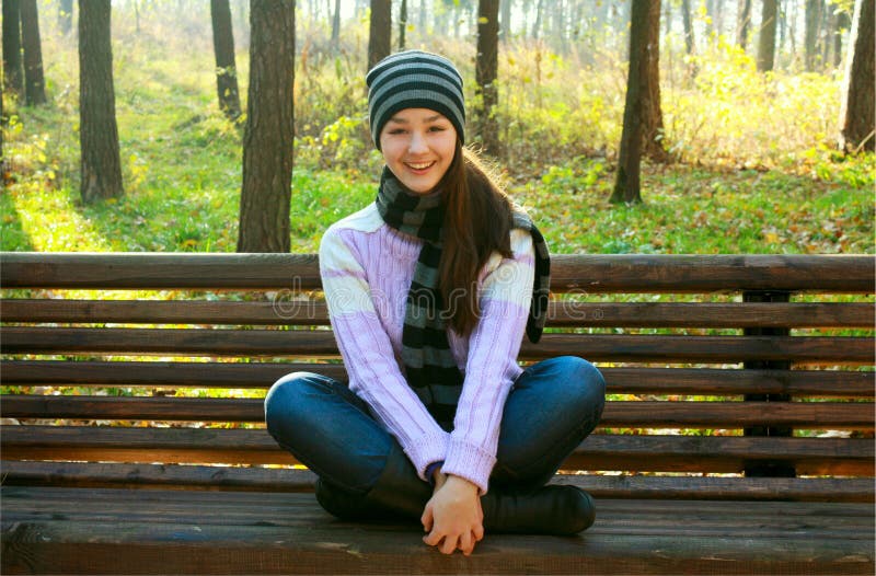 Happy Young Girl Sitting on Bench Stock Photo - Image of brunette ...