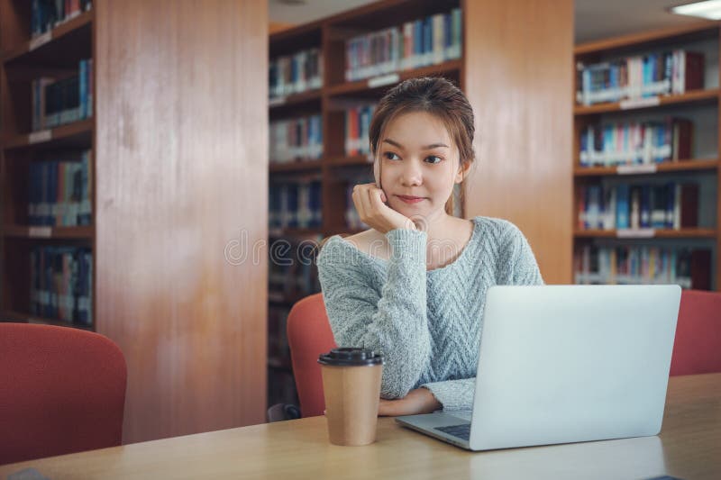 Happy Young Girl Student Studying at the College Library, Sitting at ...