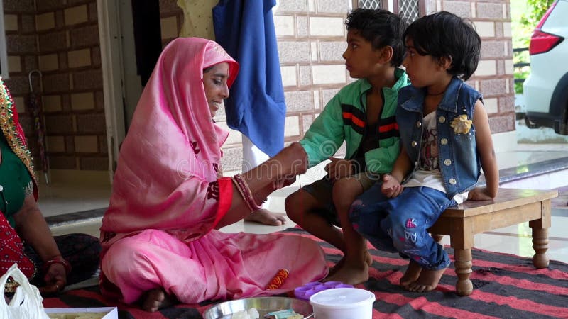 Happy Young Girl Tying Rakhi To Brother Hand During Raksha Bandhan Festival At Home Stock Video
