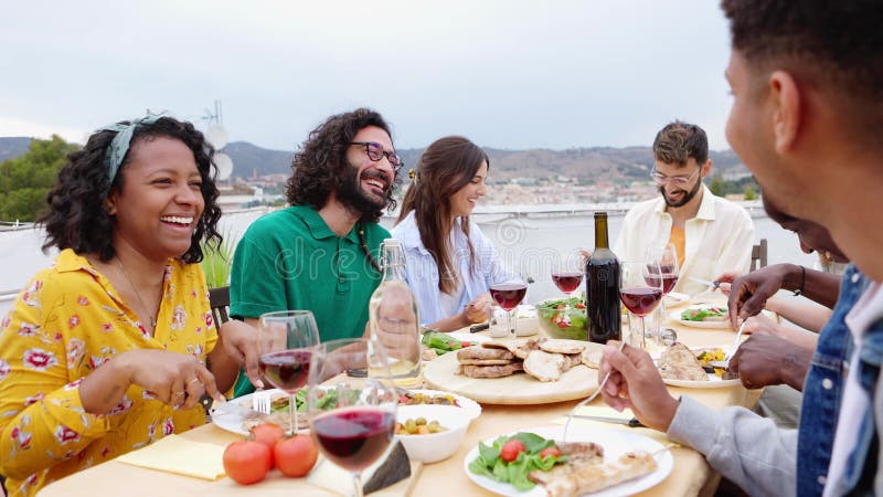 Group Of Multiracial Young Friends Hanging Out While Having Party At