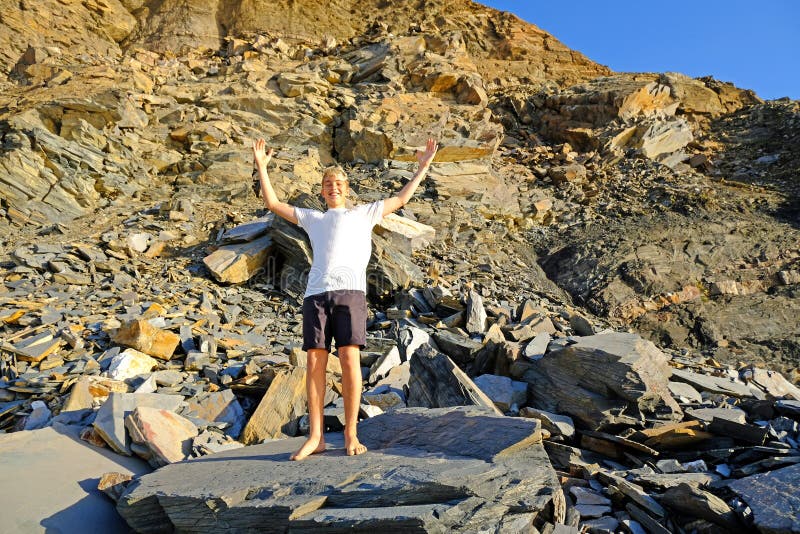 Happy Young Guy on the Rocks on the Beach Stock Image - Image of joyful ...
