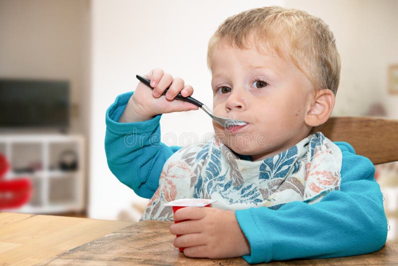Happy Young Healthy Boy Eating Yogurt Stock Image - Image of eating ...