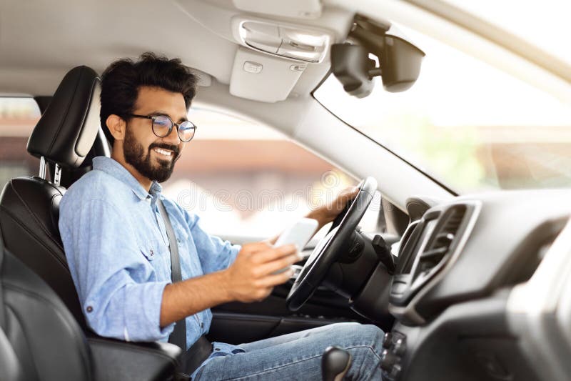 Happy Young Indian Guy Using Smartphone while Driving Car Stock Photo ...