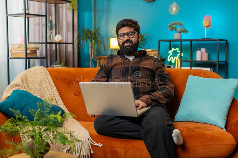 Happy Young Indian Man Typing Working on Laptop Browsing Internet Using ...