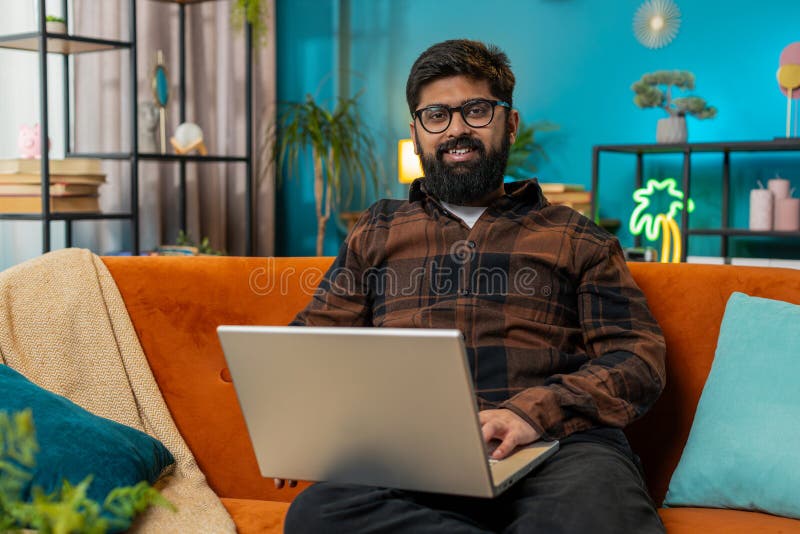 Happy Young Indian Man Typing Working on Laptop Browsing Internet Using ...
