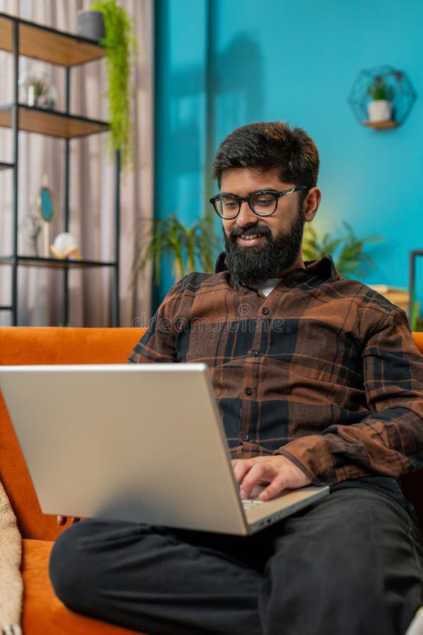 Happy Young Indian Man Typing Working on Laptop Browsing Internet Using ...