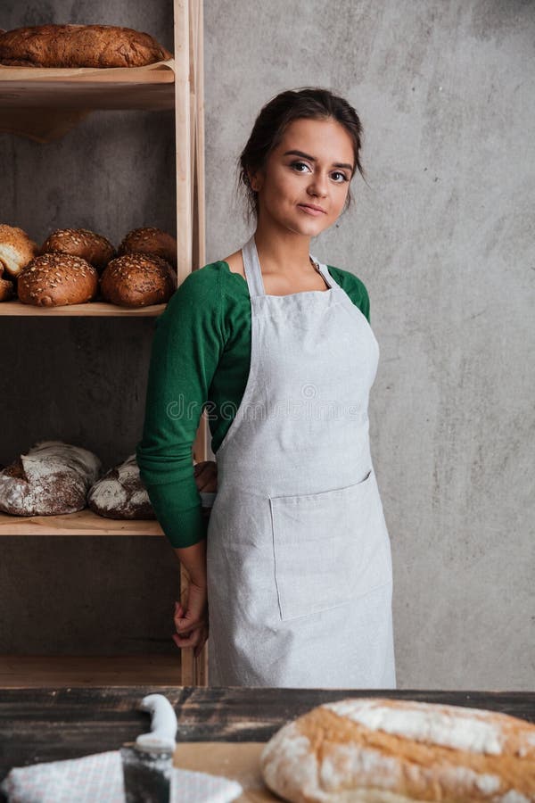 Happy Young Lady Baker Standing at Bakery Near Bread. Stock Photo ...