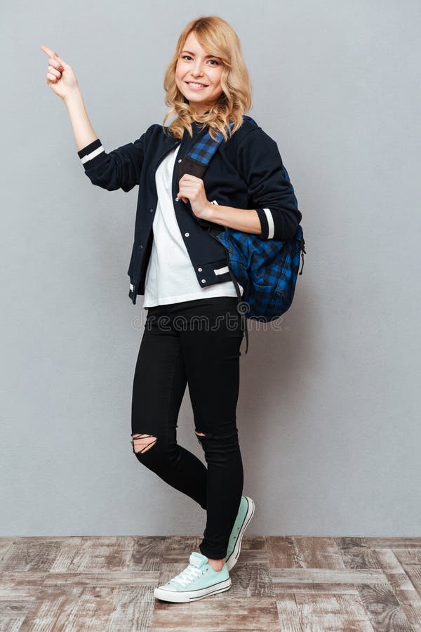Happy young lady pointing stock photo. Image of learn - 96240566
