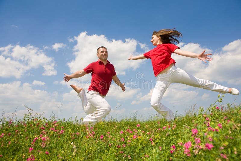 Happy Young Love Couple - Jumping Stock Photo - Image of success ...