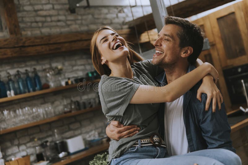 Happy Young Lovely Couple in the Kitchen Hugging Each Other Stock Photo ...