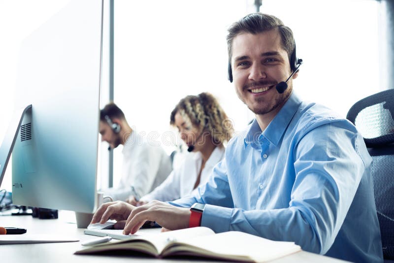 Happy Young Male Customer Support Executive Working in Office. Stock ...