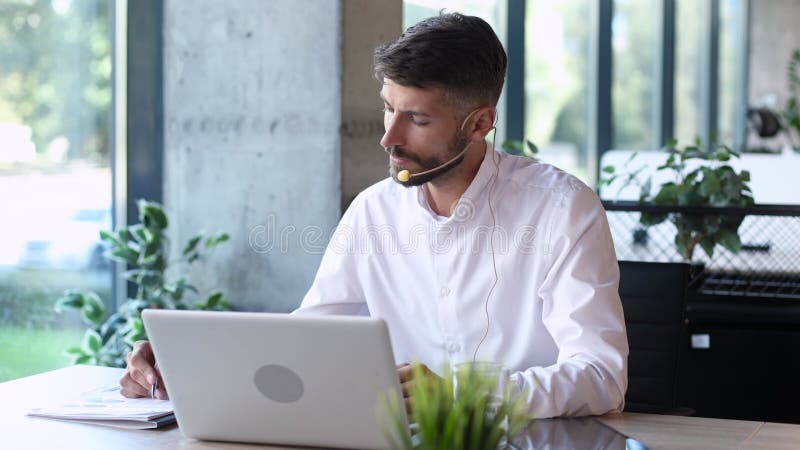 Happy Young Male Customer Support Executive Working in Office. Stock ...