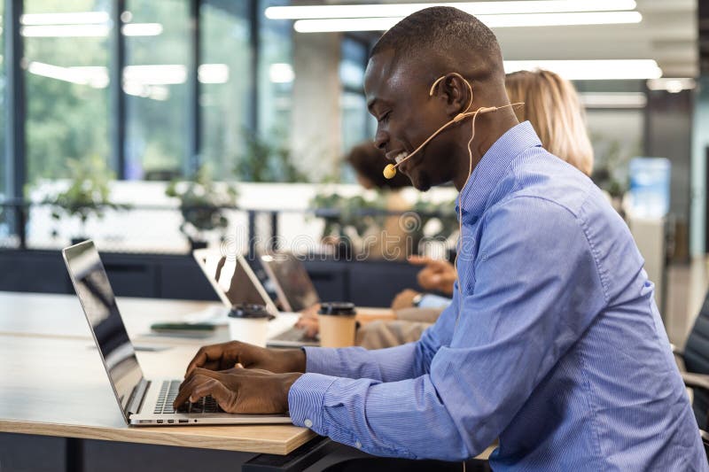 Happy Young Male Customer Support Executive Working in Office. Stock ...