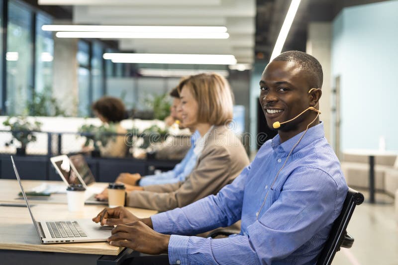 Happy Young Male Customer Support Executive Working in Office. Stock ...