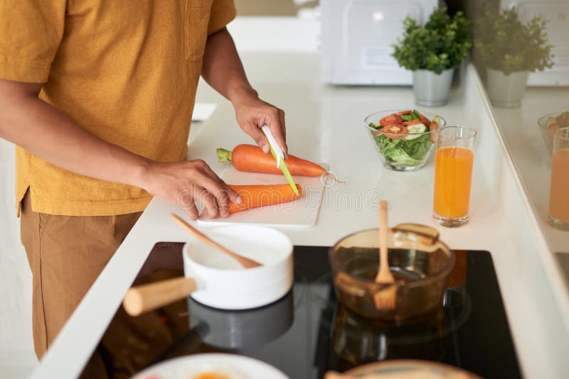 Happy Young Man Cutting Vegetables in Kitchen Stock Photo - Image of ...