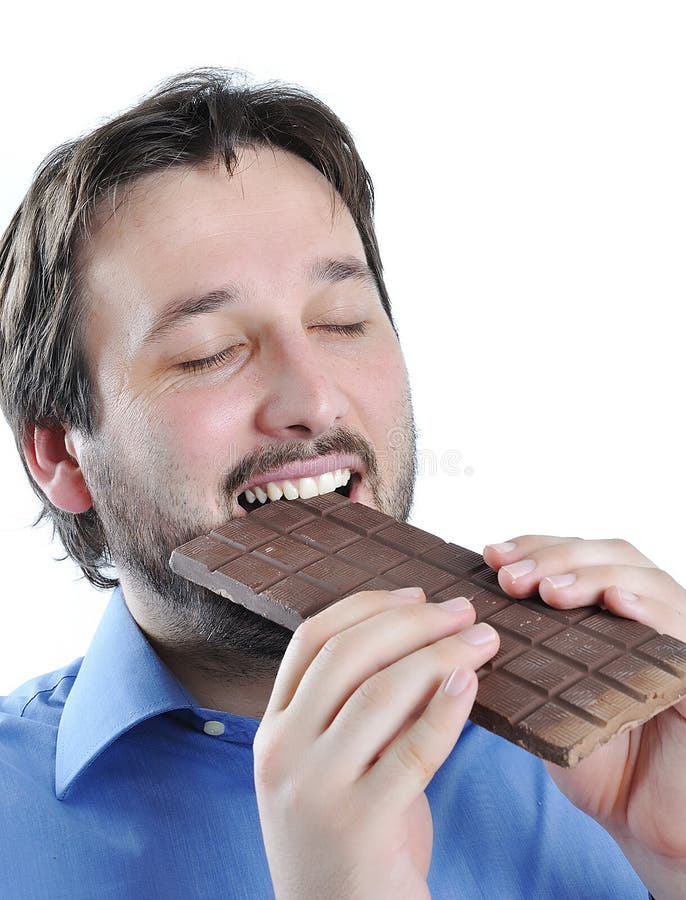 Happy Young Man Eating Chocolate Stock Photo - Image of hands, bite ...