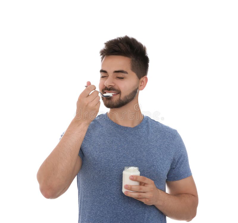 Happy Young Man Eating Tasty Yogurt on Background Stock Image - Image ...