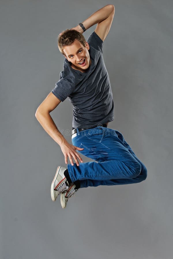 Happy young man jumping stock photo. Image of masculine - 17209464