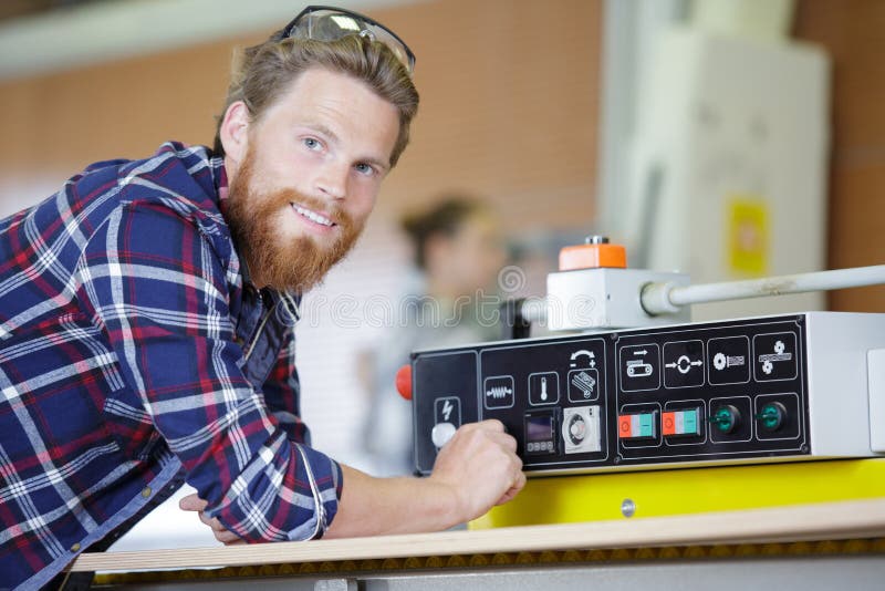 Happy Young Man Operating Machine Stock Photo - Image of carpentry ...