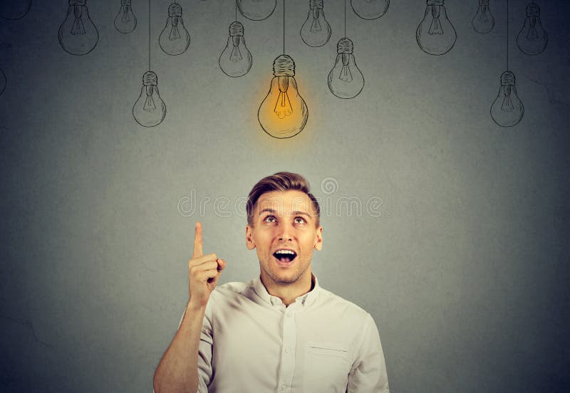 Happy Young Man Pointing at Light Bulb Has a Solution Stock Photo ...