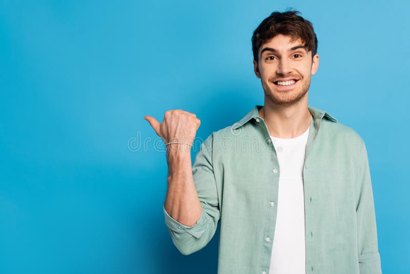 Young Man Pointing with Thumb while Stock Image - Image of handsome ...