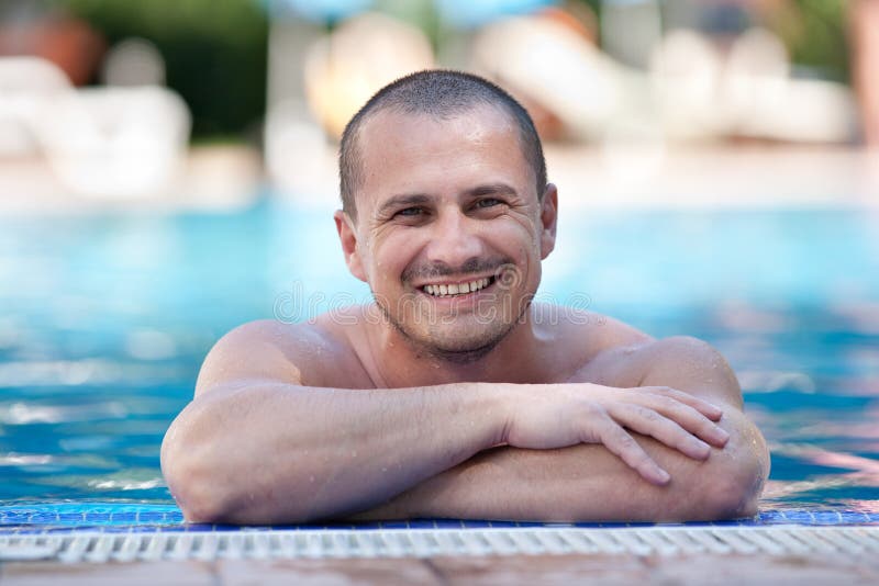 Happy young man in pool stock photo. Image of attractive - 15658456