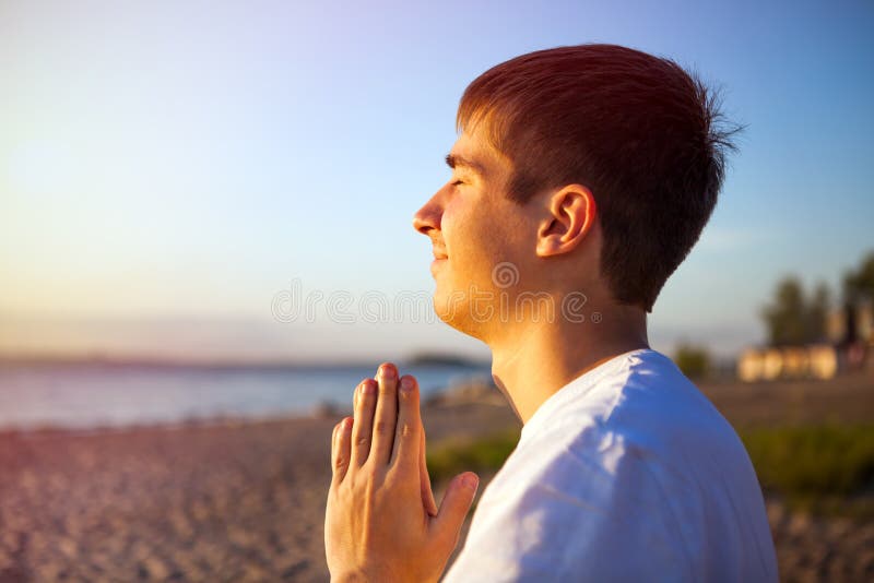 Young Man praying stock image. Image of quiet, seashore - 125851773